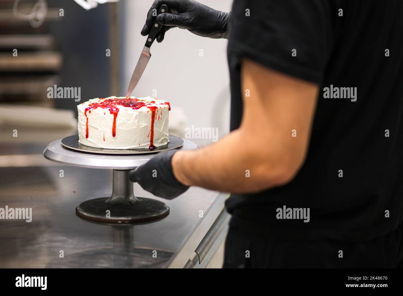 Bleeding monster cake with knife on cake stand Stock Photo - Alamy
