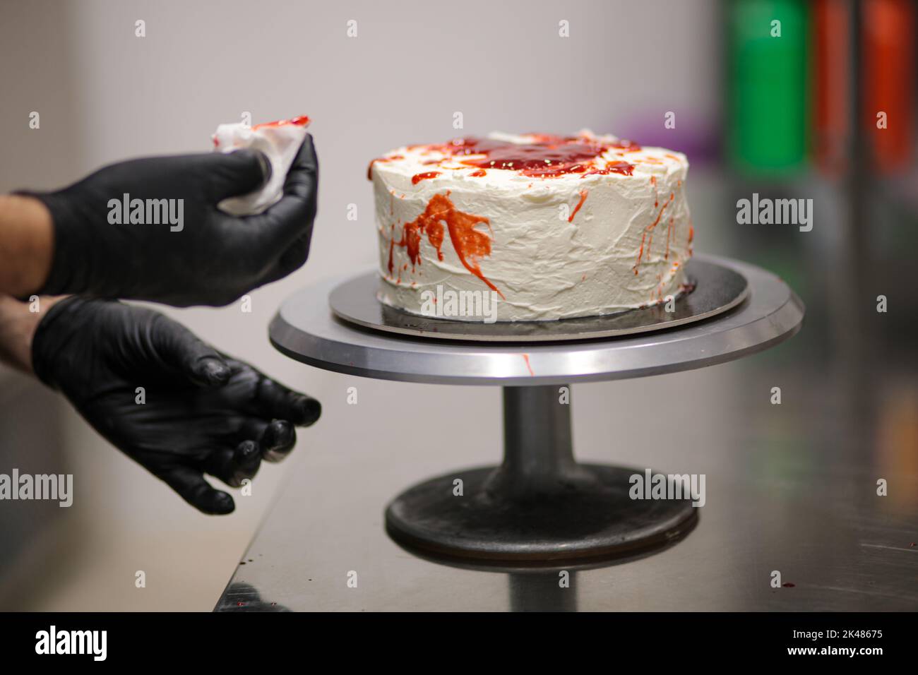 Bleeding monster cake with knife on cake stand Stock Photo - Alamy
