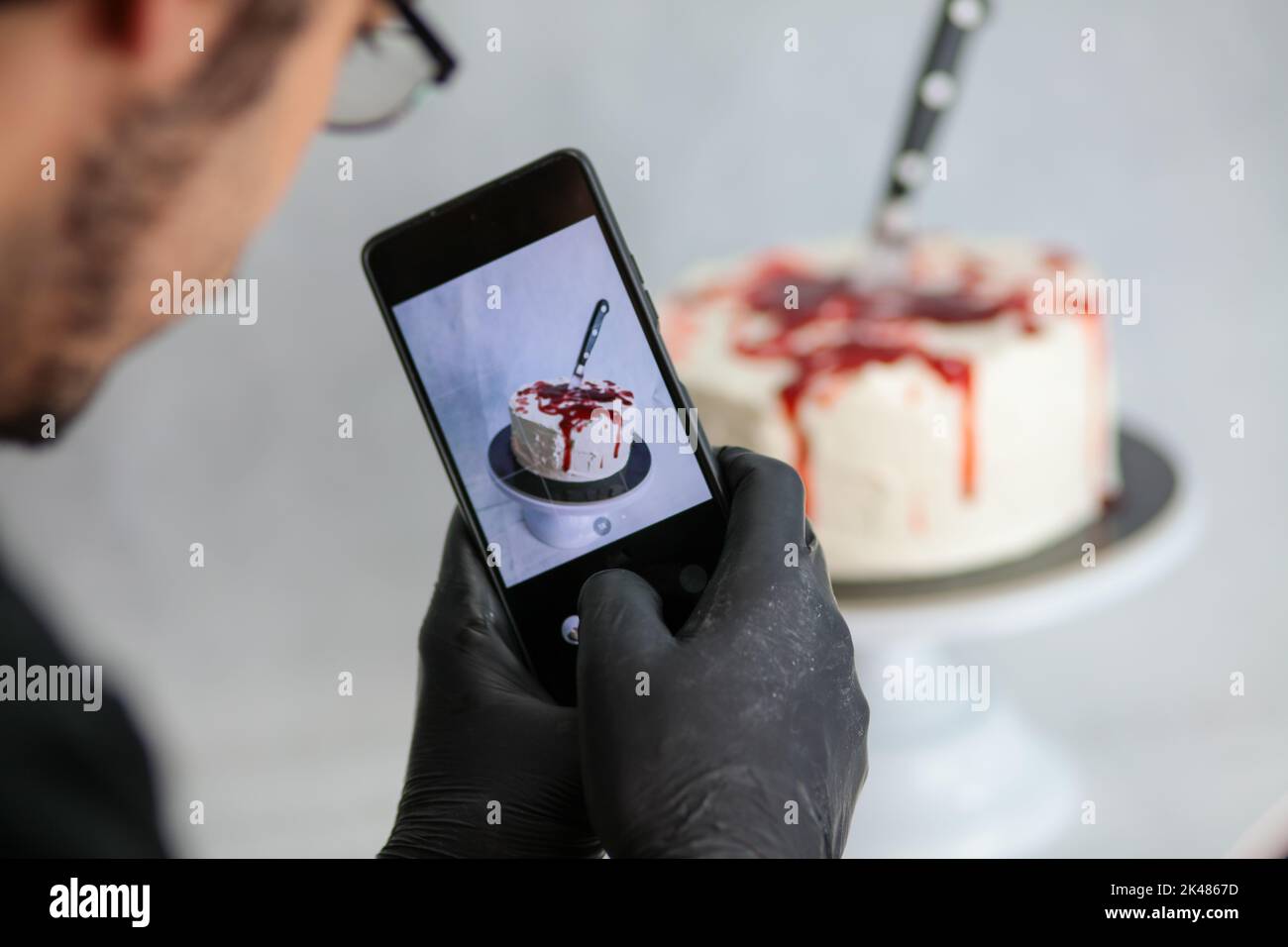 Photographing a bleeding monster cake with knife on cake stand Stock ...