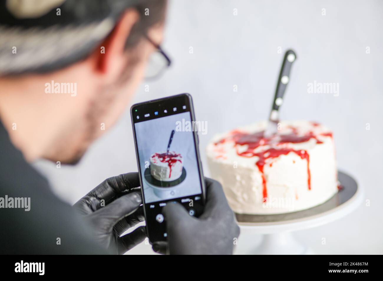 Photographing a bleeding monster cake with knife on cake stand Stock ...