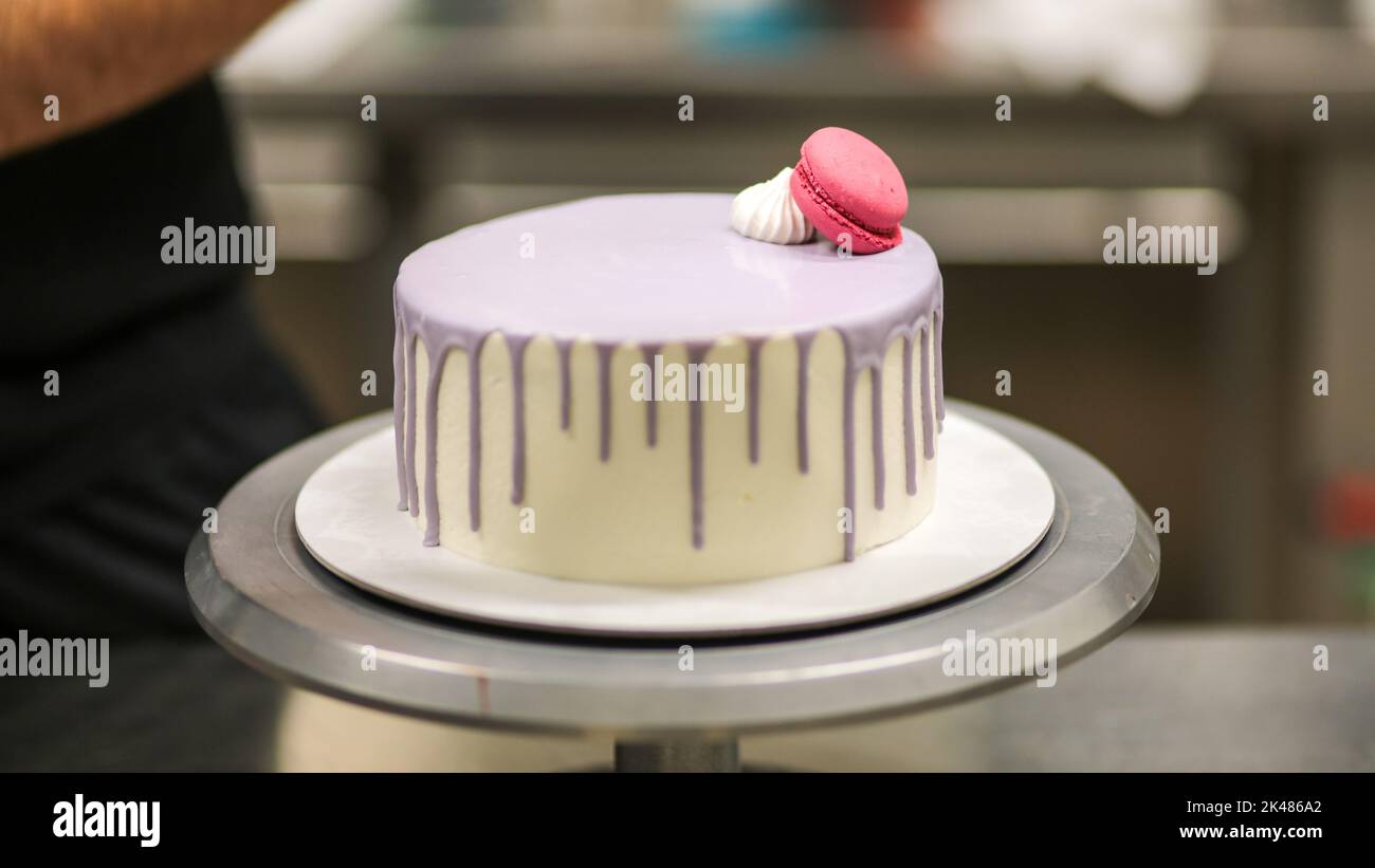 chef usign macaron , flowers and text sign for a celebration cake Stock ...