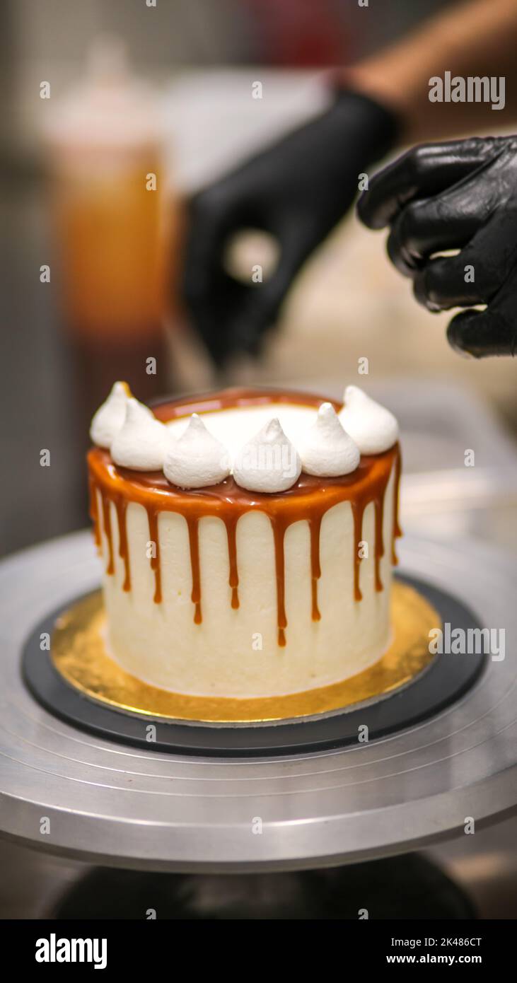 Chef decorating cake caramel cream hi-res stock photography and images ...