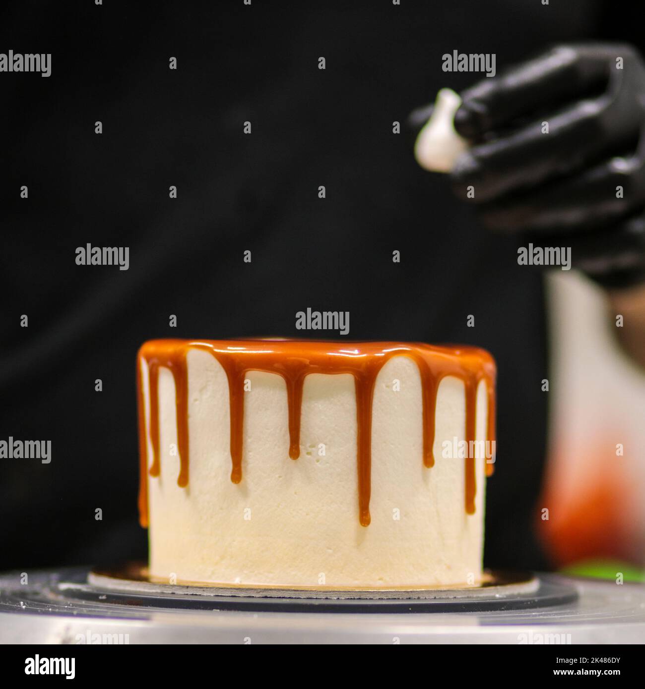 cake designer at work with a cupcake Stock Photo - Alamy