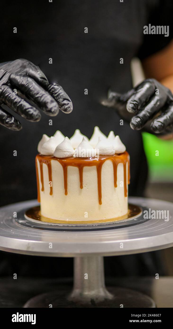 cake designer at work with a cupcake Stock Photo - Alamy