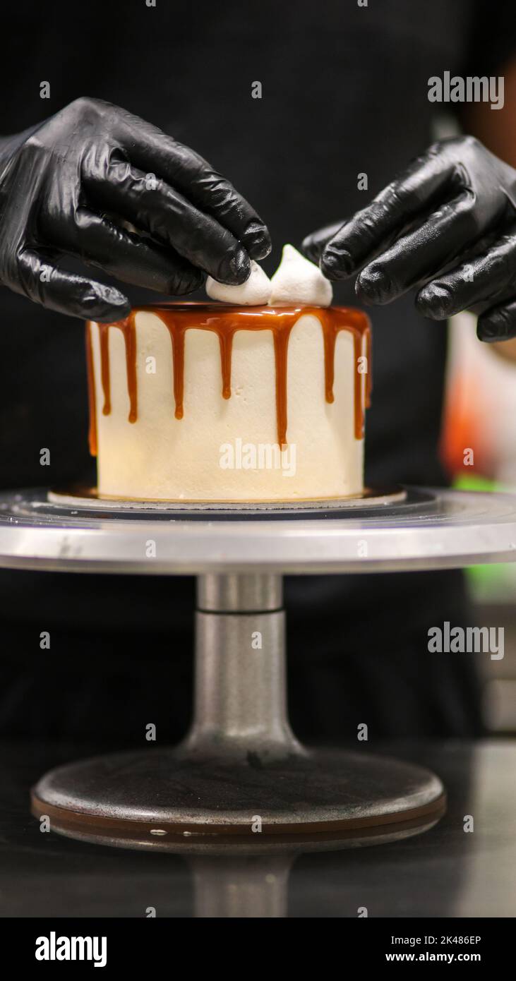 cake designer at work with a cupcake Stock Photo - Alamy