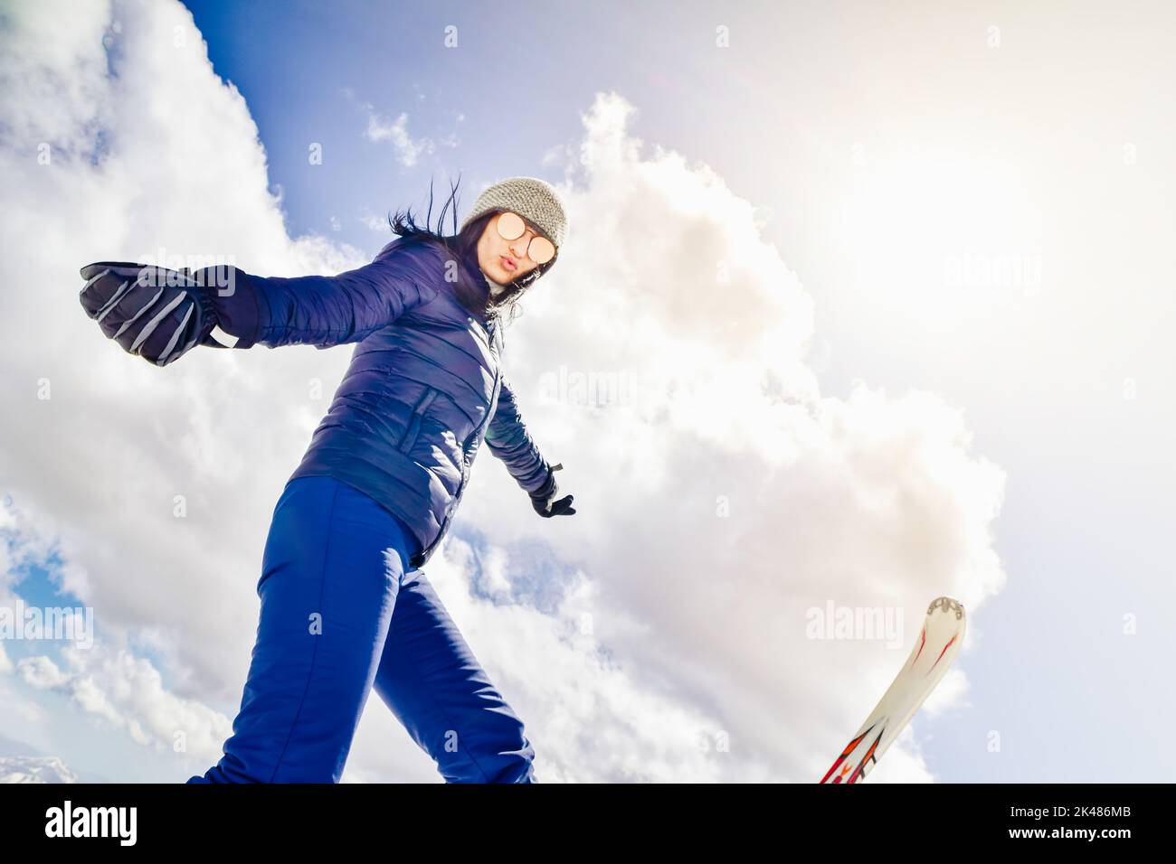 Happy excited caucasian young woman pose ski up for social media post ...