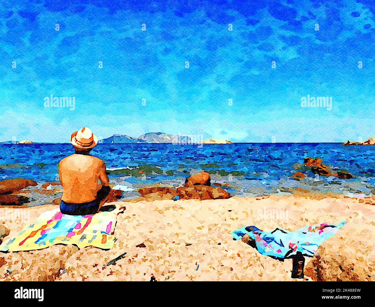 A man sitting from behind in contemplation on the beach by the sea ...