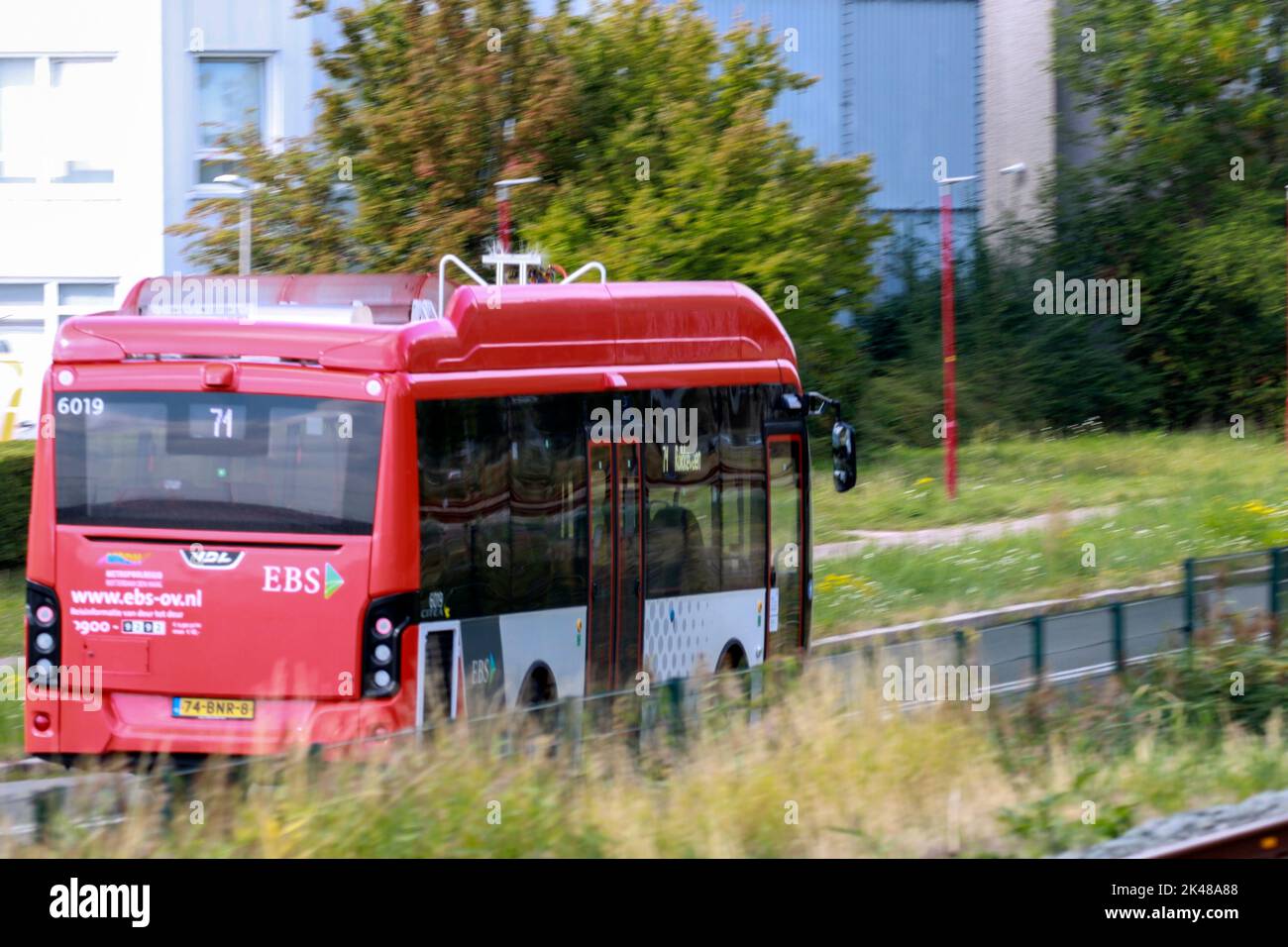 Red and white regional busses of EBS at train station Lansingerland ...