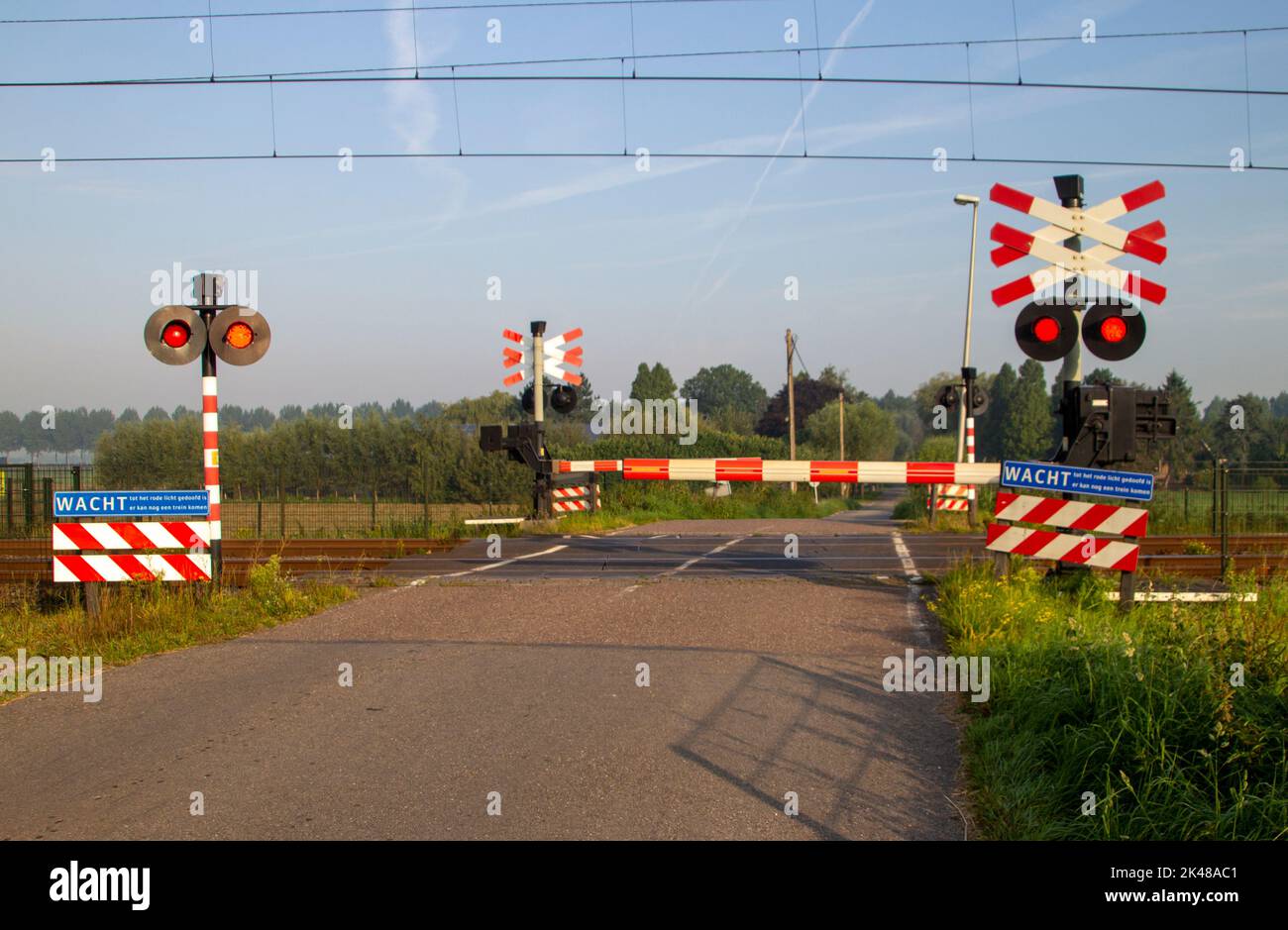 Closed railroad crossing with red lights at the Tweede Tochtweg in ...