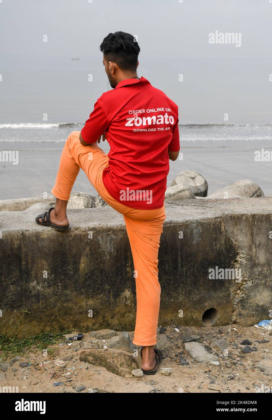 Mumbai, India. 01st Oct, 2022. A Zomato delivery man is seen standing ...