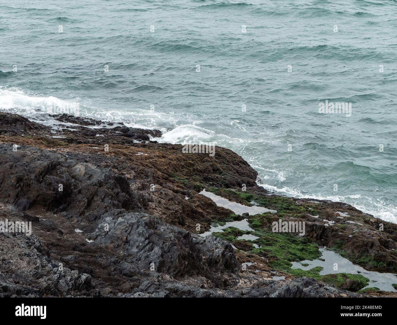 Cold sea water and coastal rocks. Cloudy weather on the Atlantic coast ...