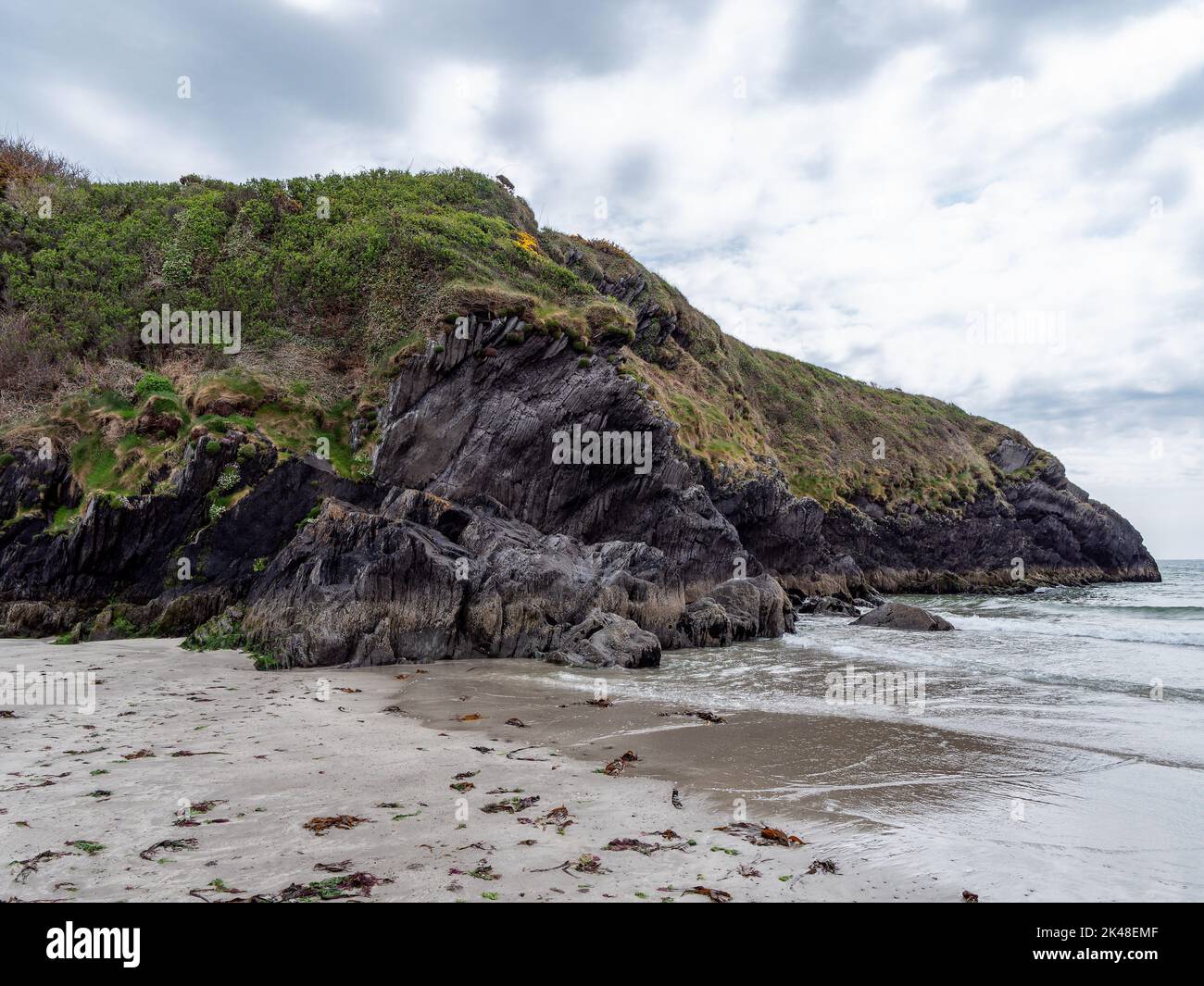 Sheer cliffs at Warren Beach. Beautiful sky. The picturesque Irish ...