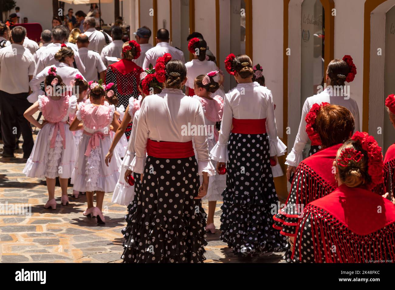 Procession of Spanish women and girls in traditional dress during ...