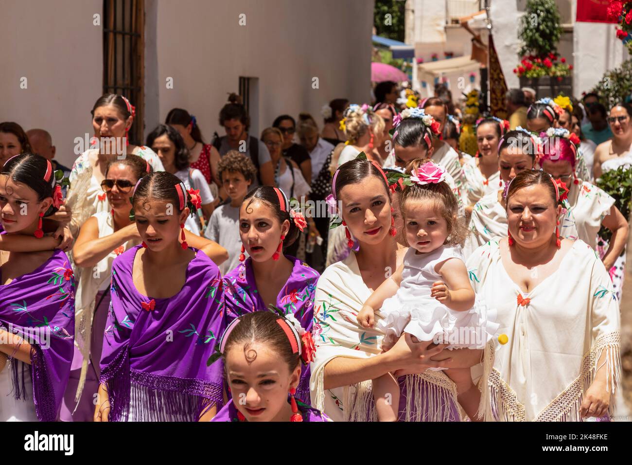Procession of Spanish women and girls in traditional dress during ...
