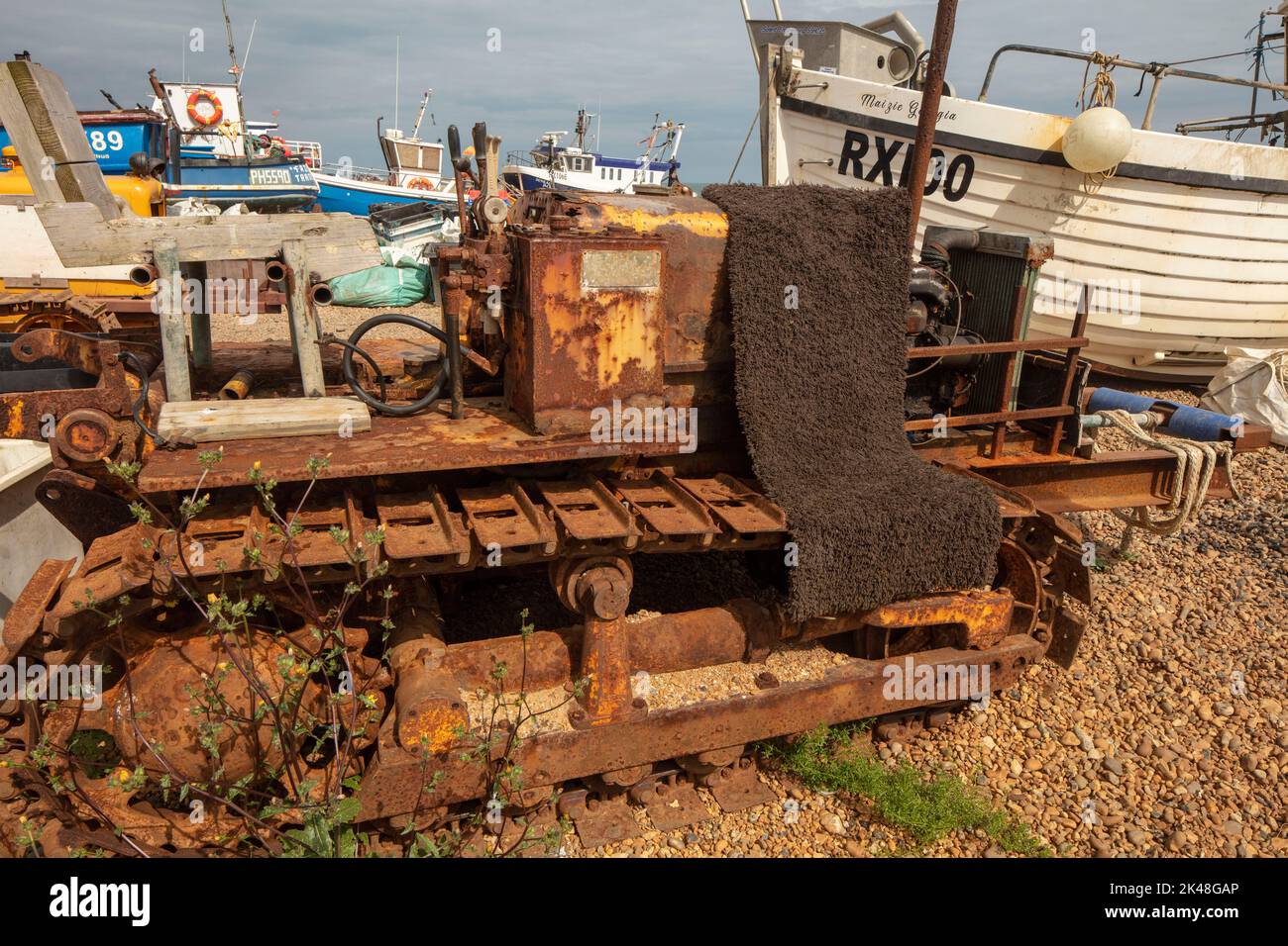 Found still life of rusting tractor, and boat, in the fishing beachside ...
