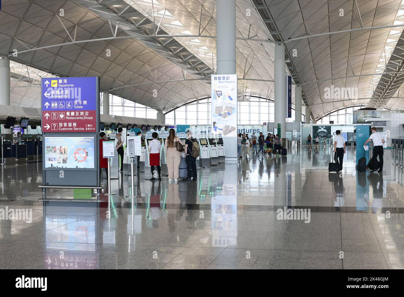 travelers and visitors with face mask check in at cathay pacific ...
