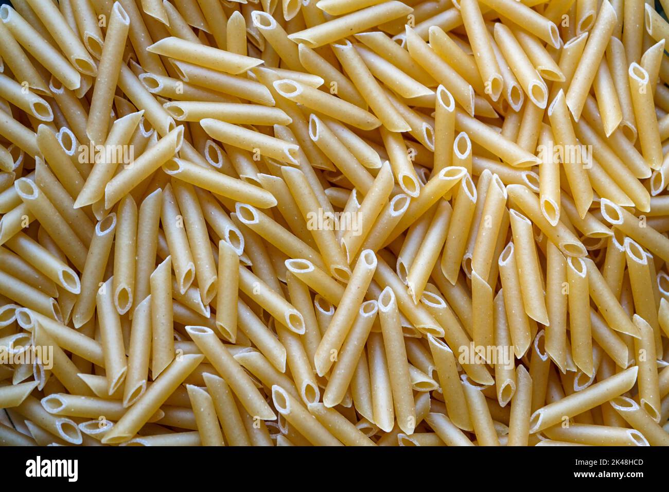 uncooked macaroni pasta background, italian food Stock Photo - Alamy