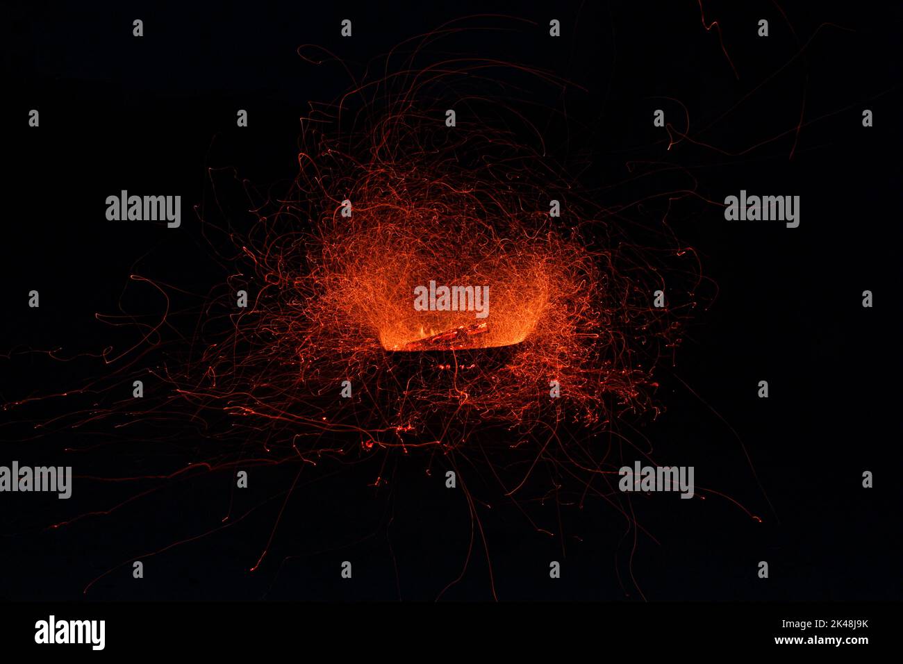 Flame of fire with flying burning red sparks on black background. Fiery ...