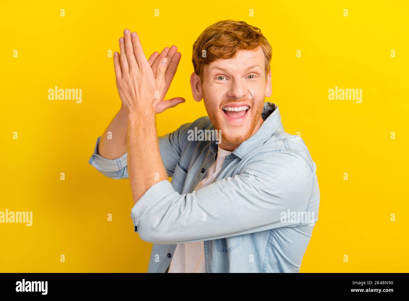Photo of cheerful positive man wear jeans shirt clapping arms smiling ...