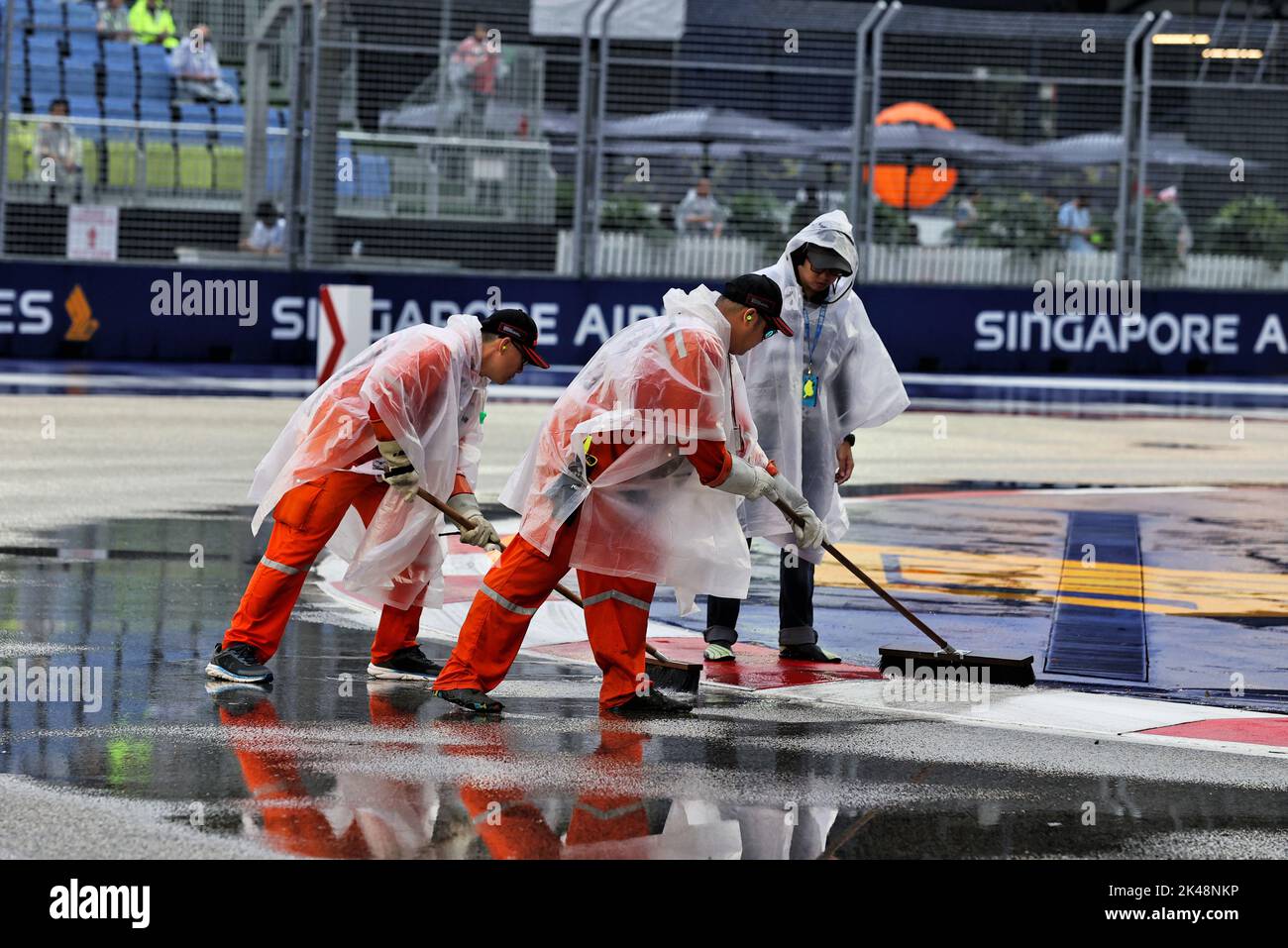Singapore. 01st Oct, 2022. Circuit atmosphere - marshals sweep the circuit of rain water ...