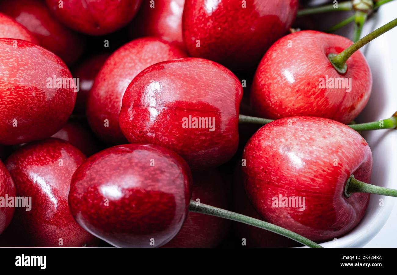 Cherries in close-up. Red fruit with green petioles. The structure of ...