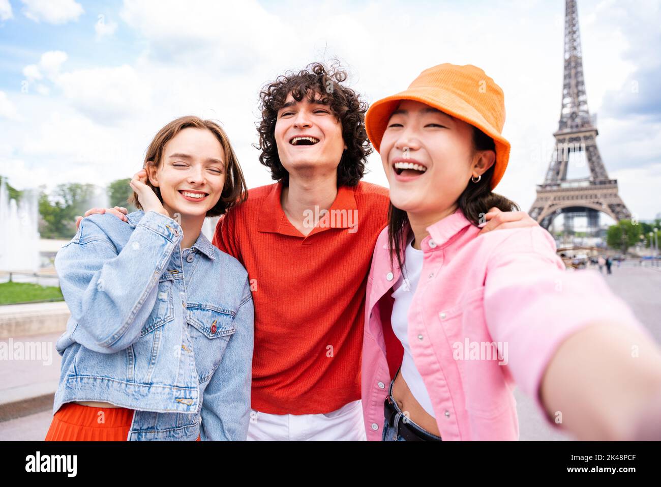 Group of young happy friends visiting Paris and Eiffel Tower, Trocadero ...