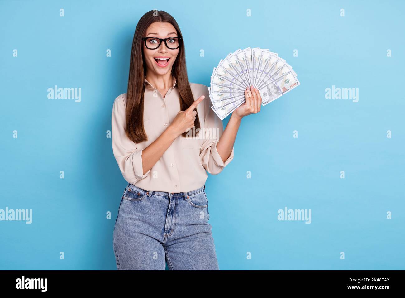 Photo of pretty impressed stylish lady arm hold show income salary ...