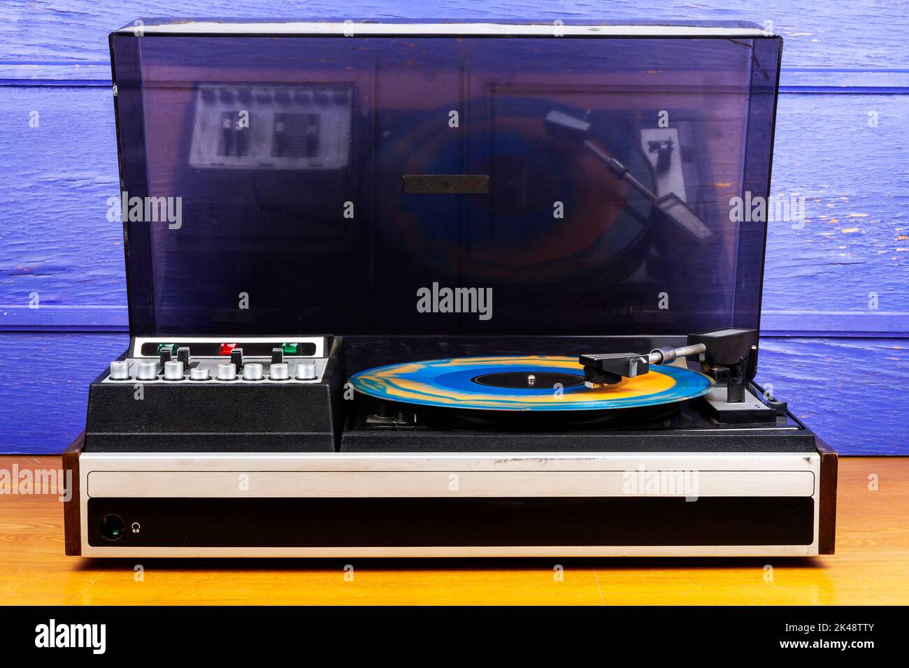 Vintage turntable vinyl record player with blue and orange vinyl on a ...