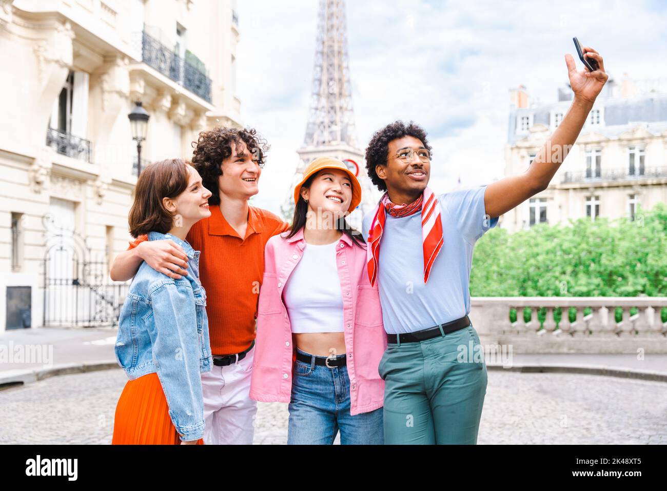 Group of young happy friends visiting Paris and Eiffel Tower, Trocadero ...