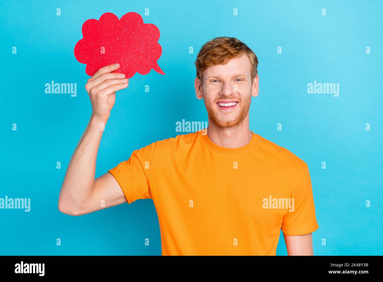 Photo of cute red hair guy hold mind wear orange t-shirt isolated on ...