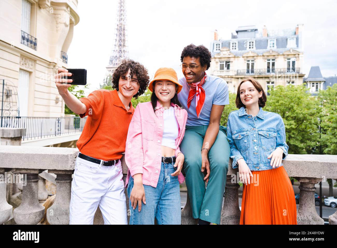 Group of young happy friends visiting Paris and Eiffel Tower, Trocadero ...