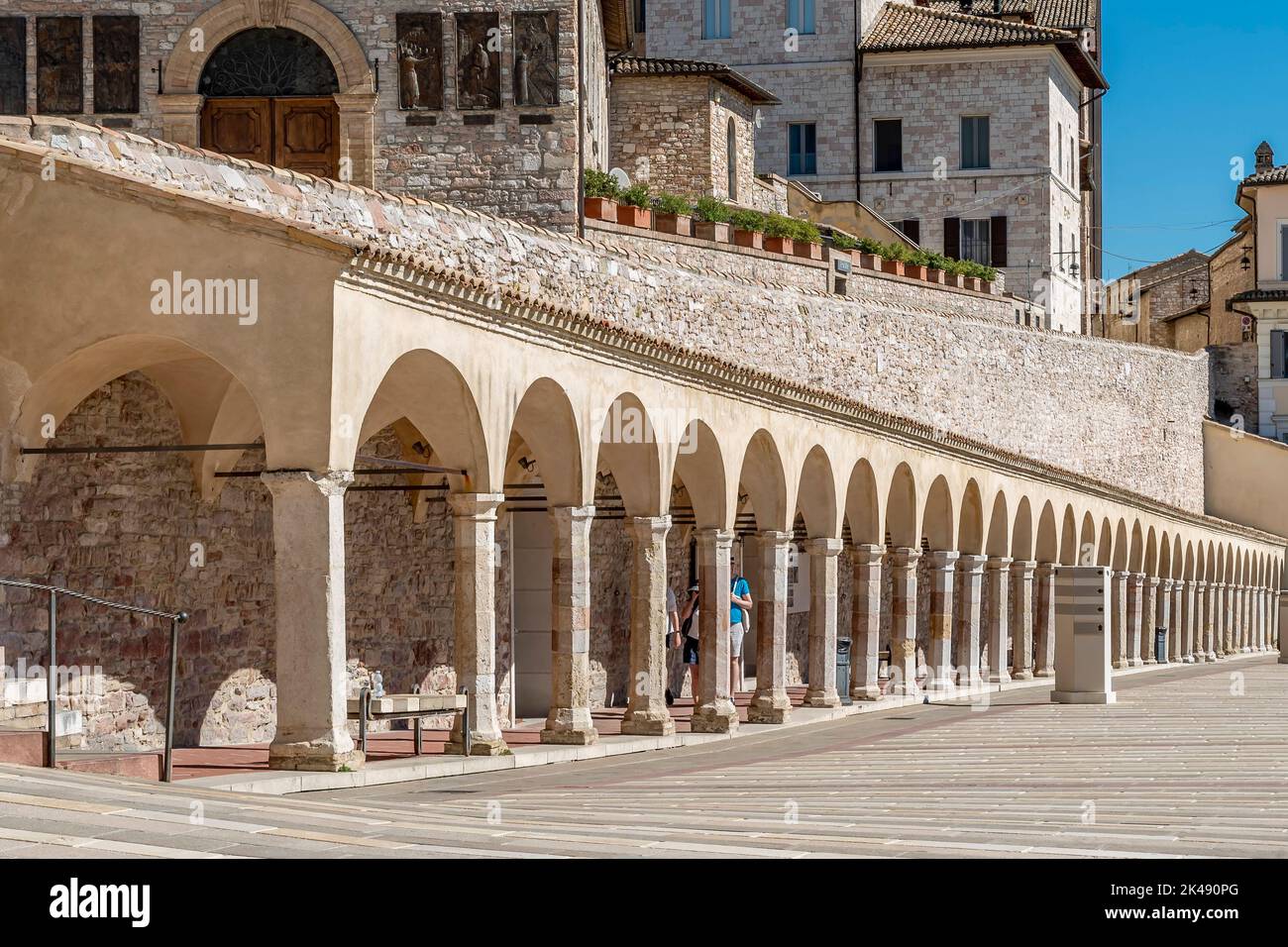 The arcades of the lower square in the historic center of Assisi ...