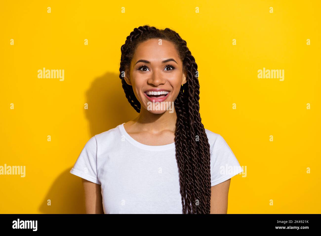 Portrait of excited astonished cheerful girl look interested up empty ...