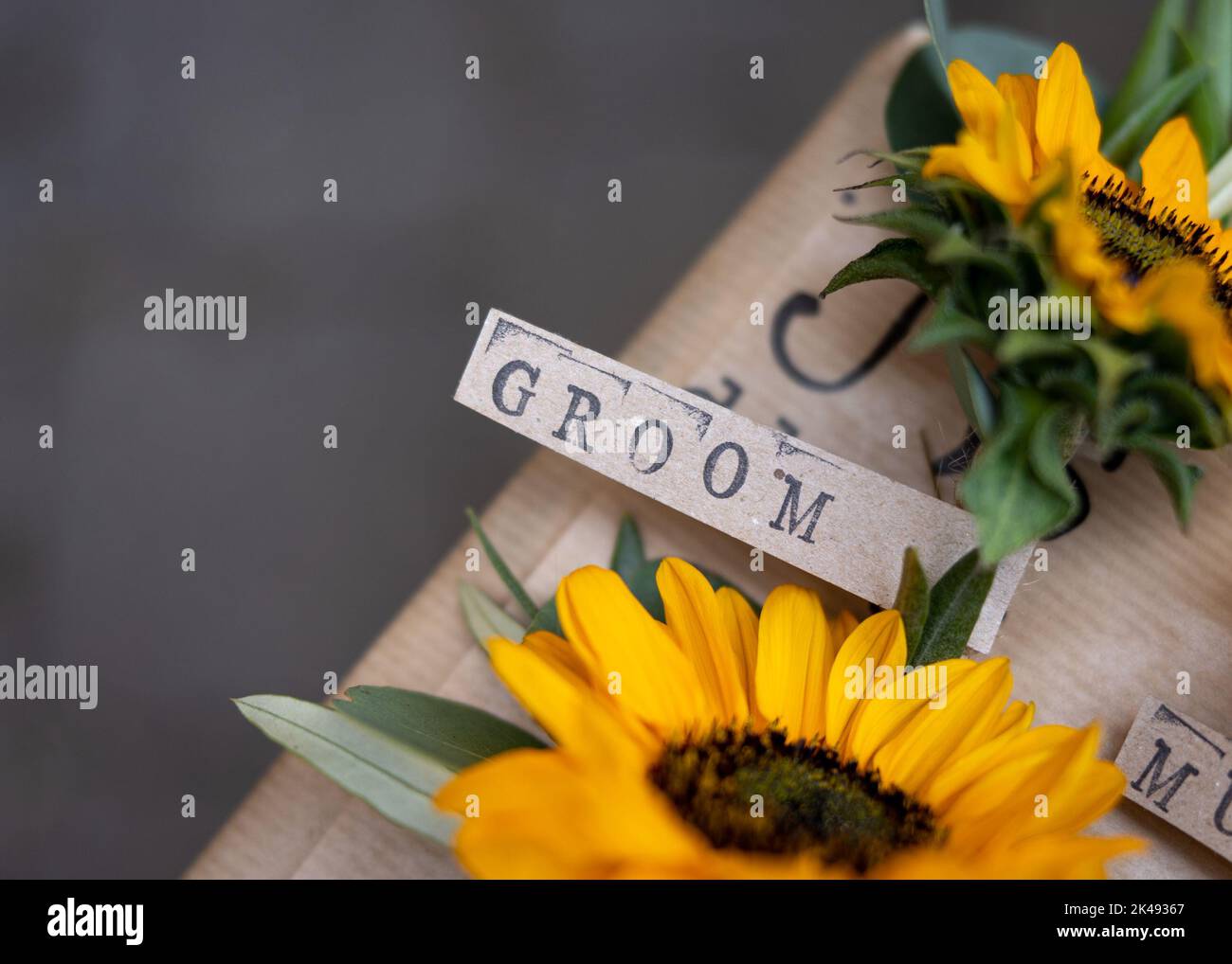 Wedding groom name badge with printed text font on sunflower corsage ...