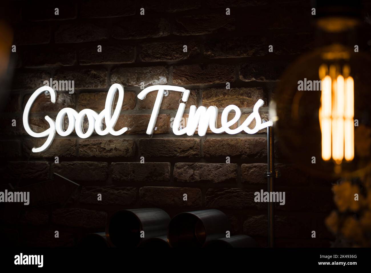 Good times neon sign lit up bright on brick wall background Stock Photo ...