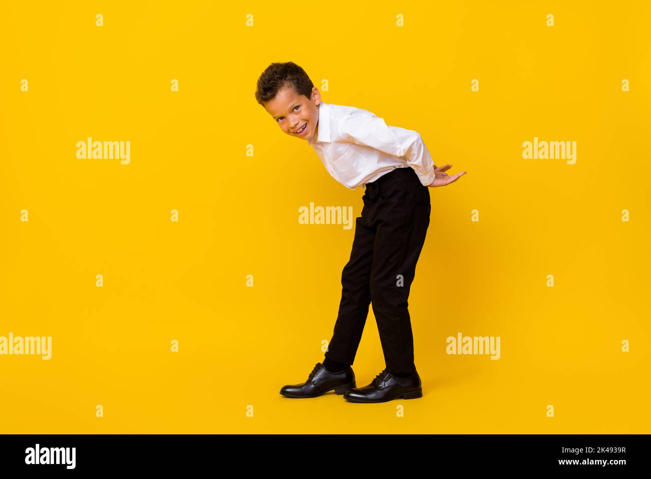 Full size profile photo of positive school boy arms hold empty space ...