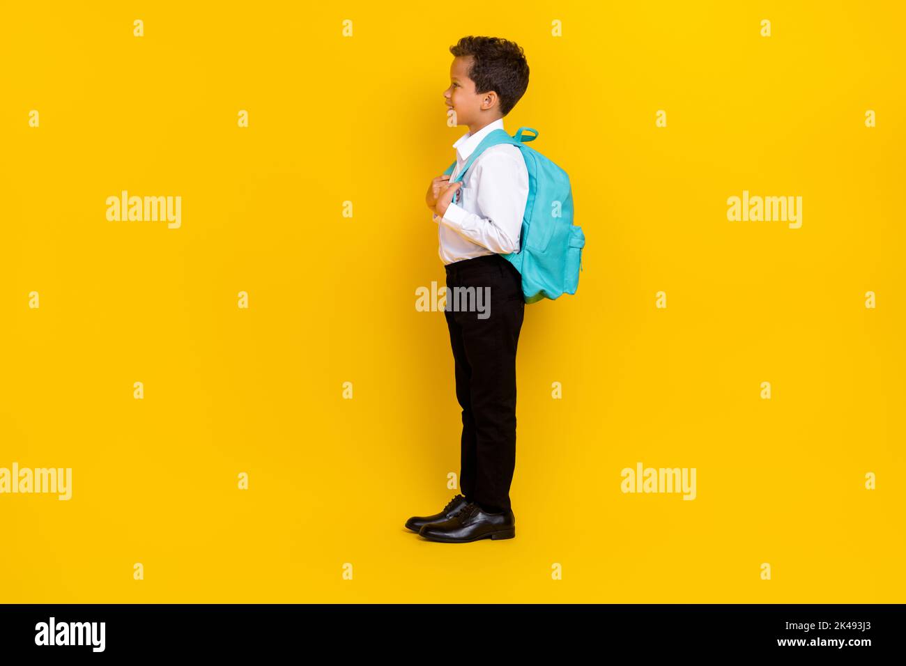 Full size profile photo of school boy standing look empty space carry ...