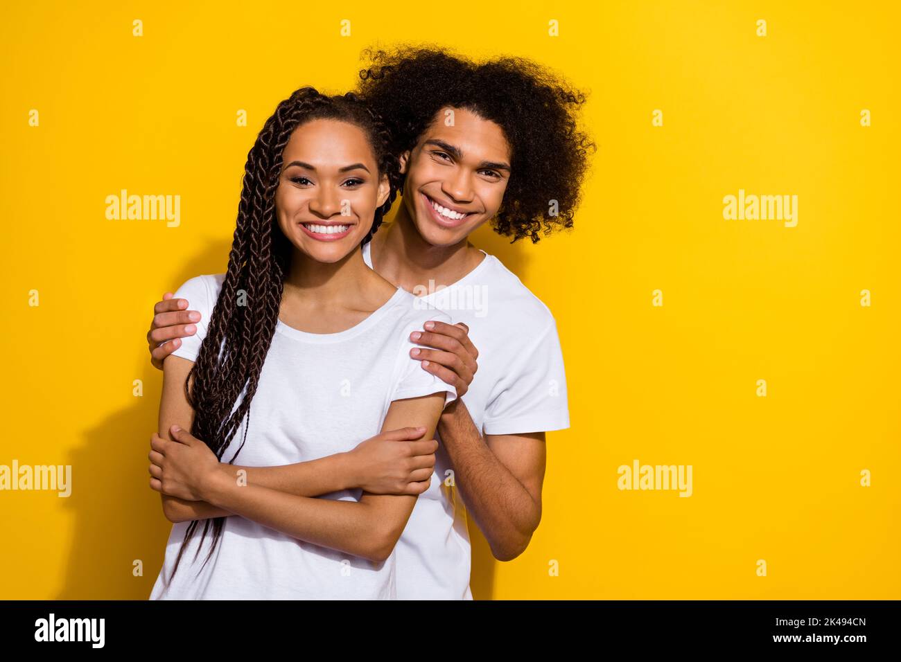 Portrait of two idyllic positive partners cuddle touch shoulders ...