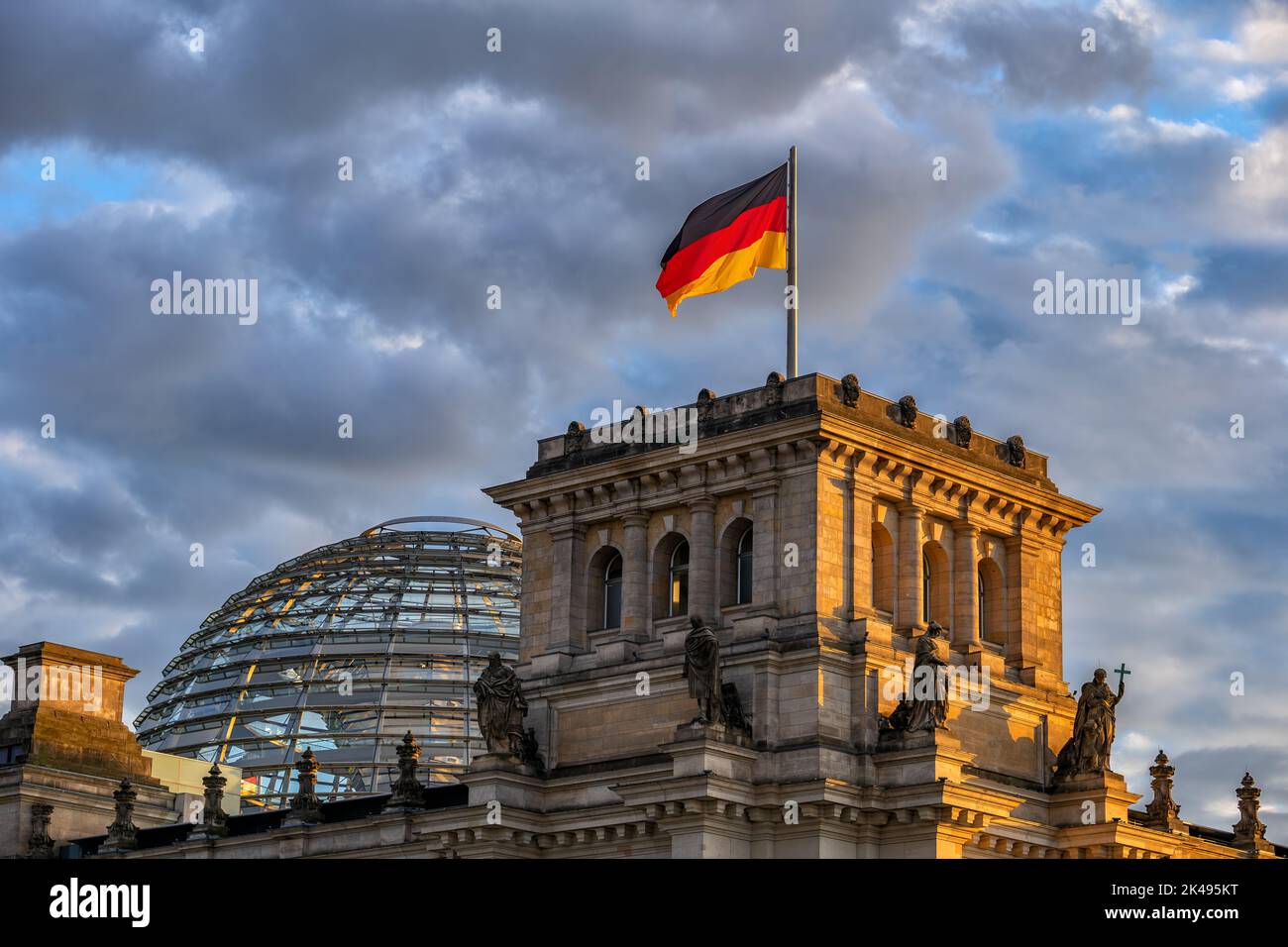 Top of the Reichstag Building with dome and National flag of Germany at ...