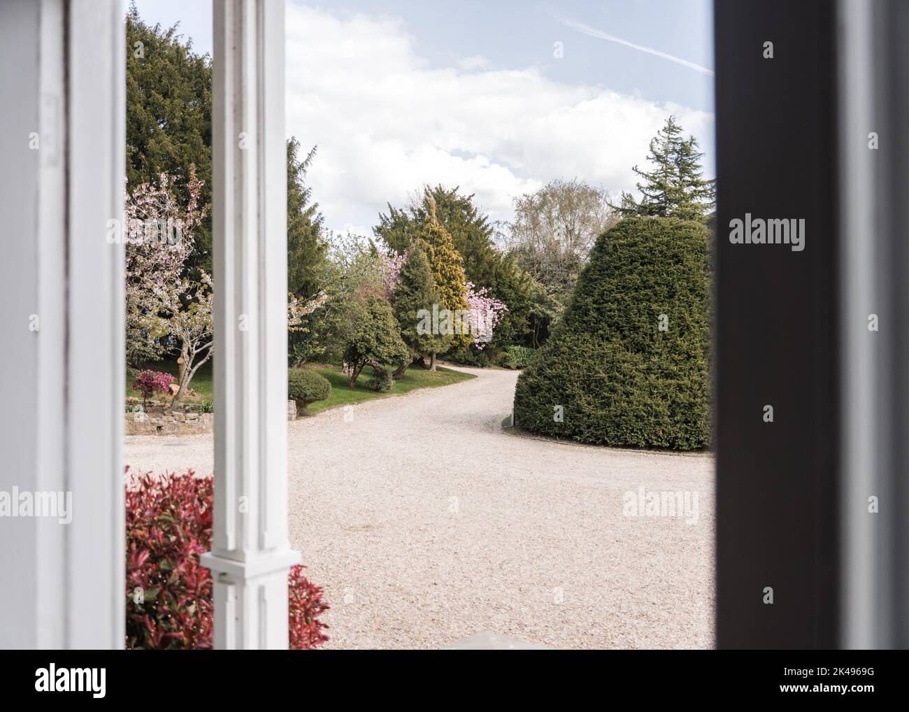 Beautiful old house driveway on summer day winding through gardens ...