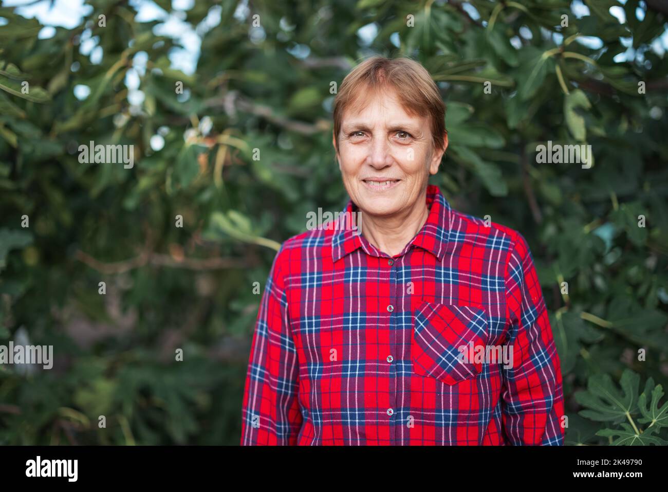 Smiling woman farmer portrait outdoor in the farmland. Agriculture and ...