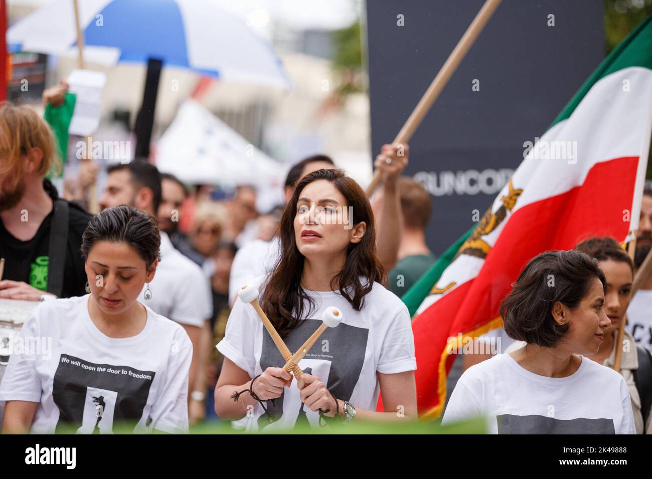 Women play drums while marching through the Streets during a rally ...