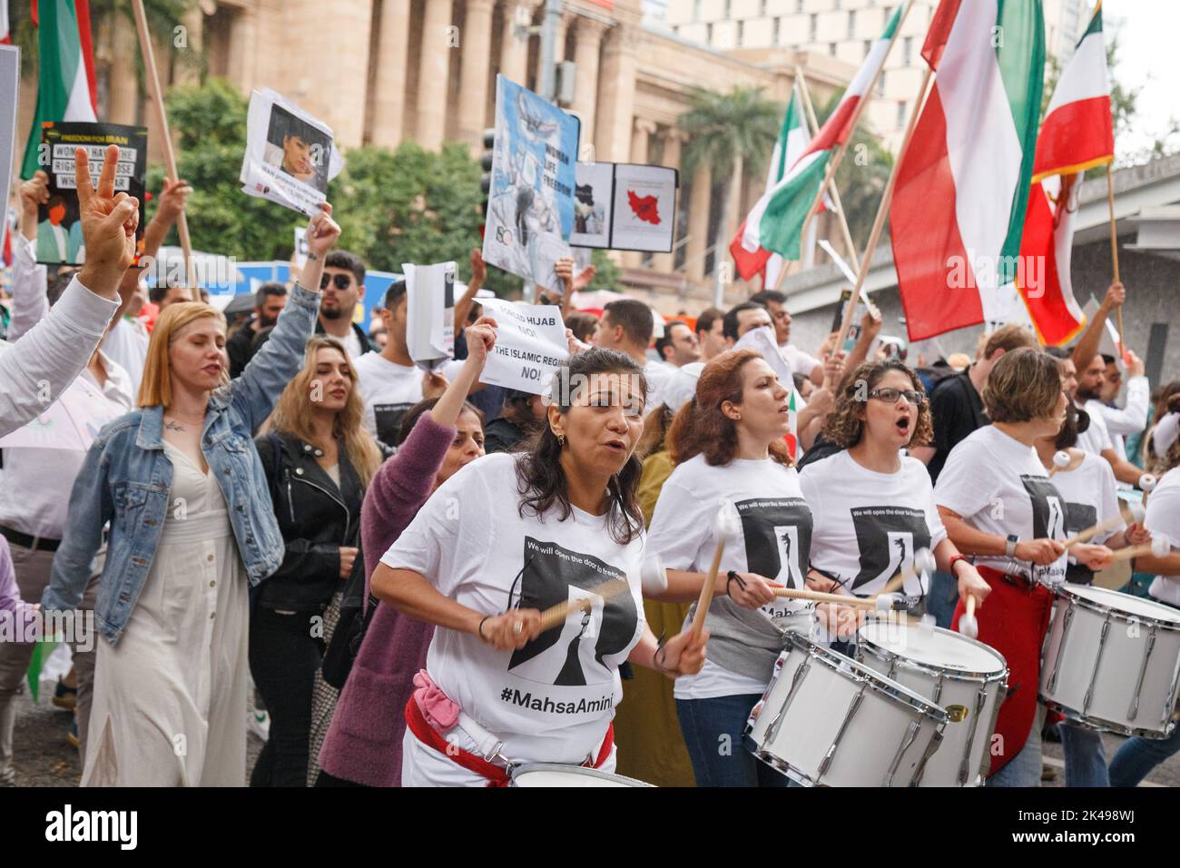 Women play drums while marching through the Streets during a rally ...