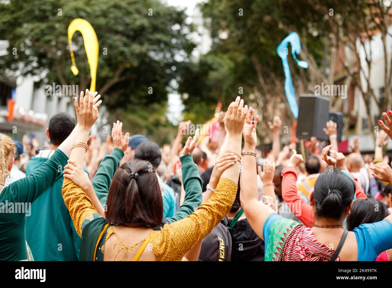 A crowd of people take part in traditional chants during the Festival ...
