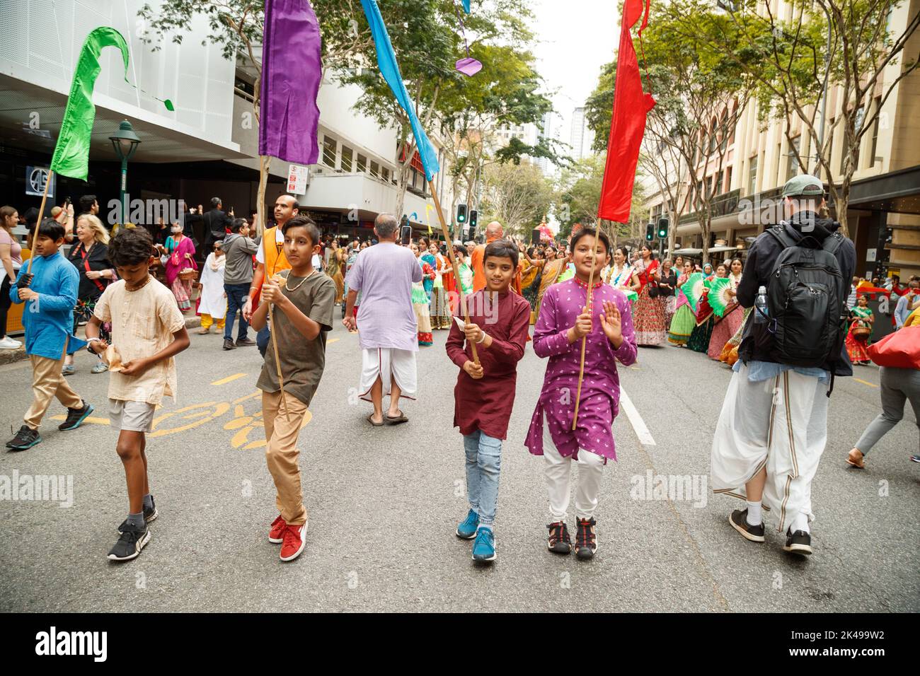 Kids wave traditional flags during the Festival of Chariots Parade in ...