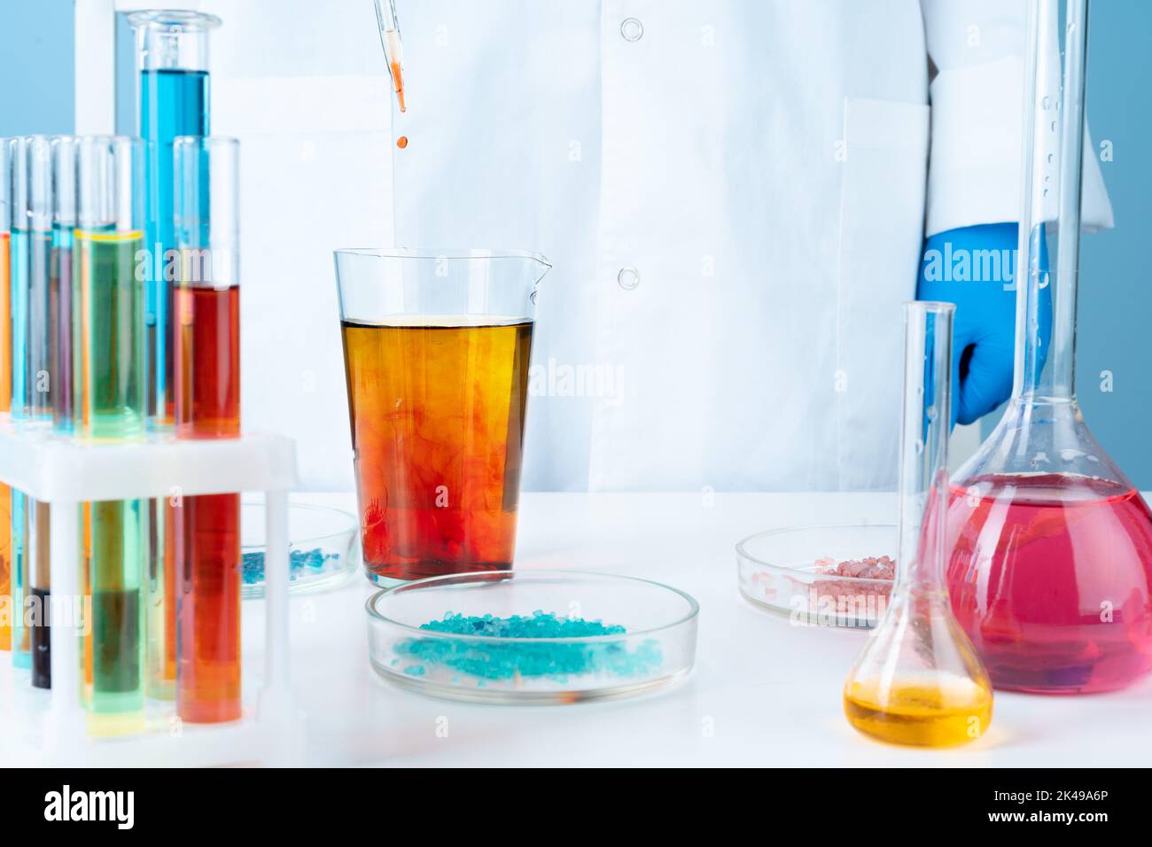 Manipulations with laboratory glass chemical containers on table Stock ...