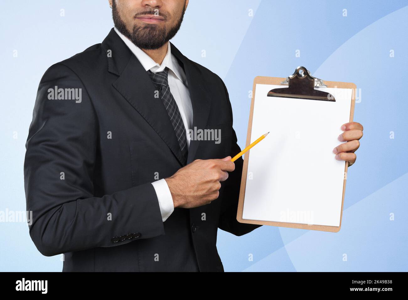Making notes. Cheerful young African businessman writing something in ...