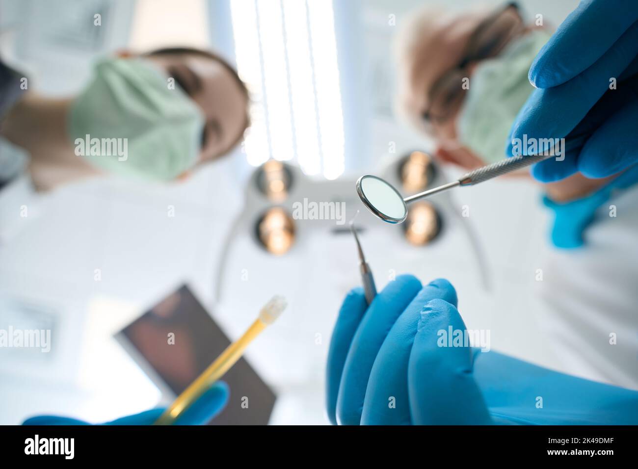 Stomatologist holding dental equipments and doing tooth surgery Stock ...