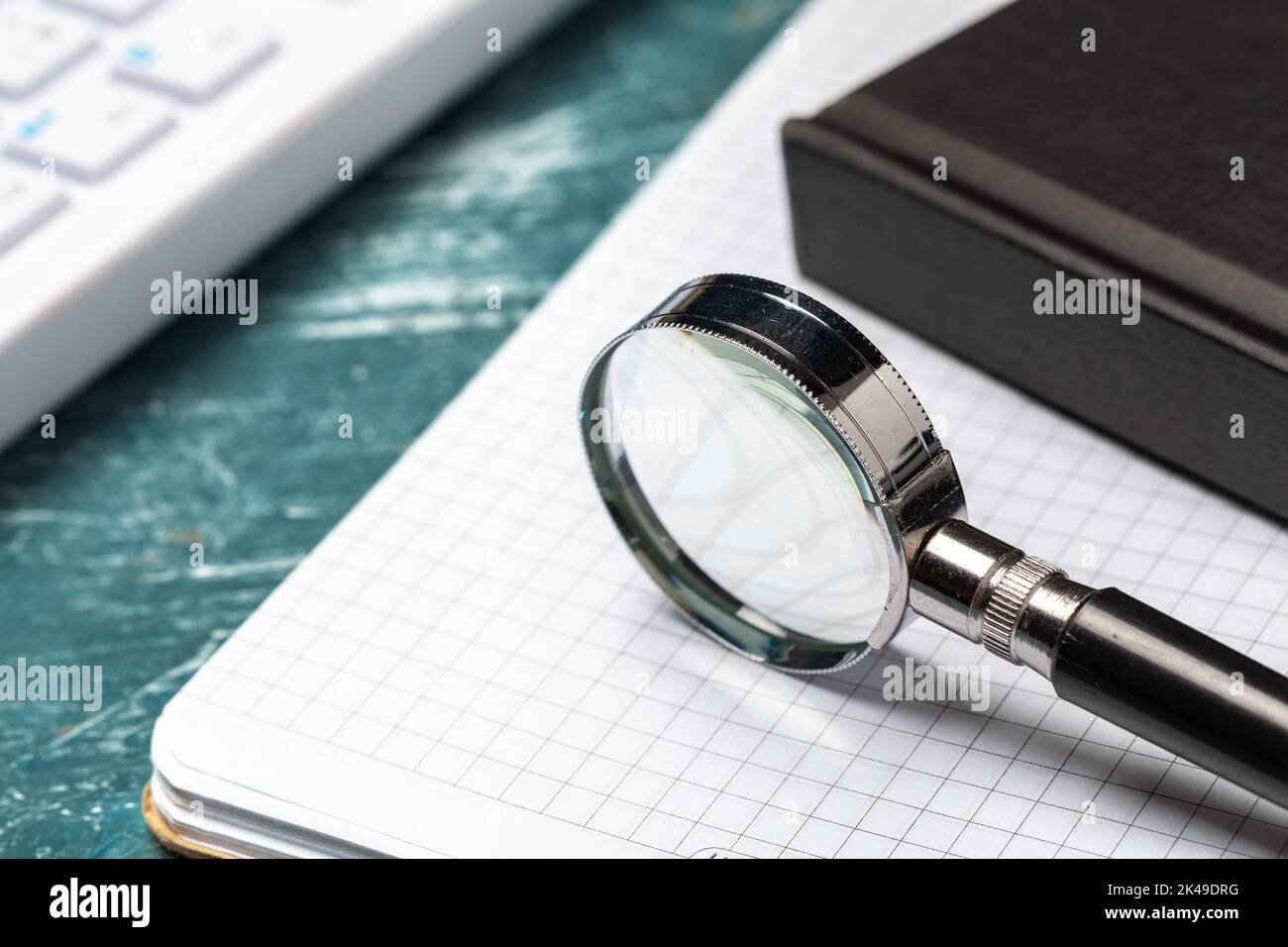 Office table with note paper, computer keyboard and supplies close up ...