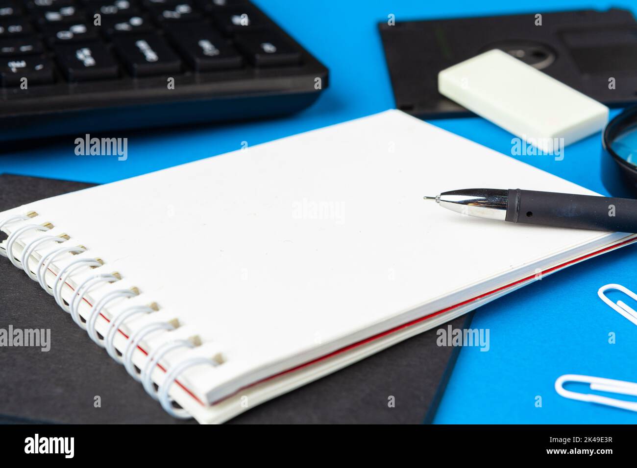 Flat lay, top view of blue office table desk. Workspace with blank note ...